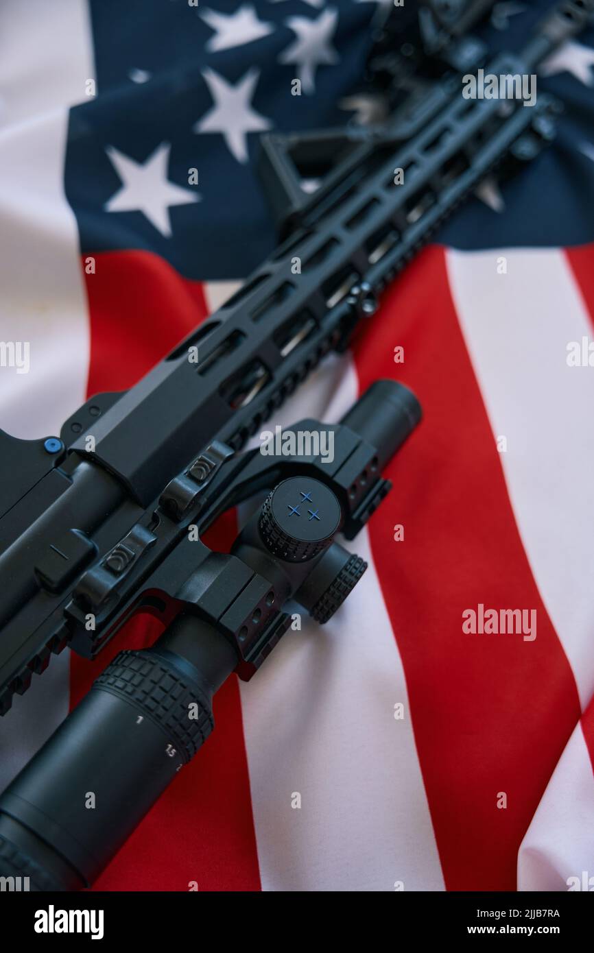 Technological assault rifle with sight lying on the USA flag Stock ...