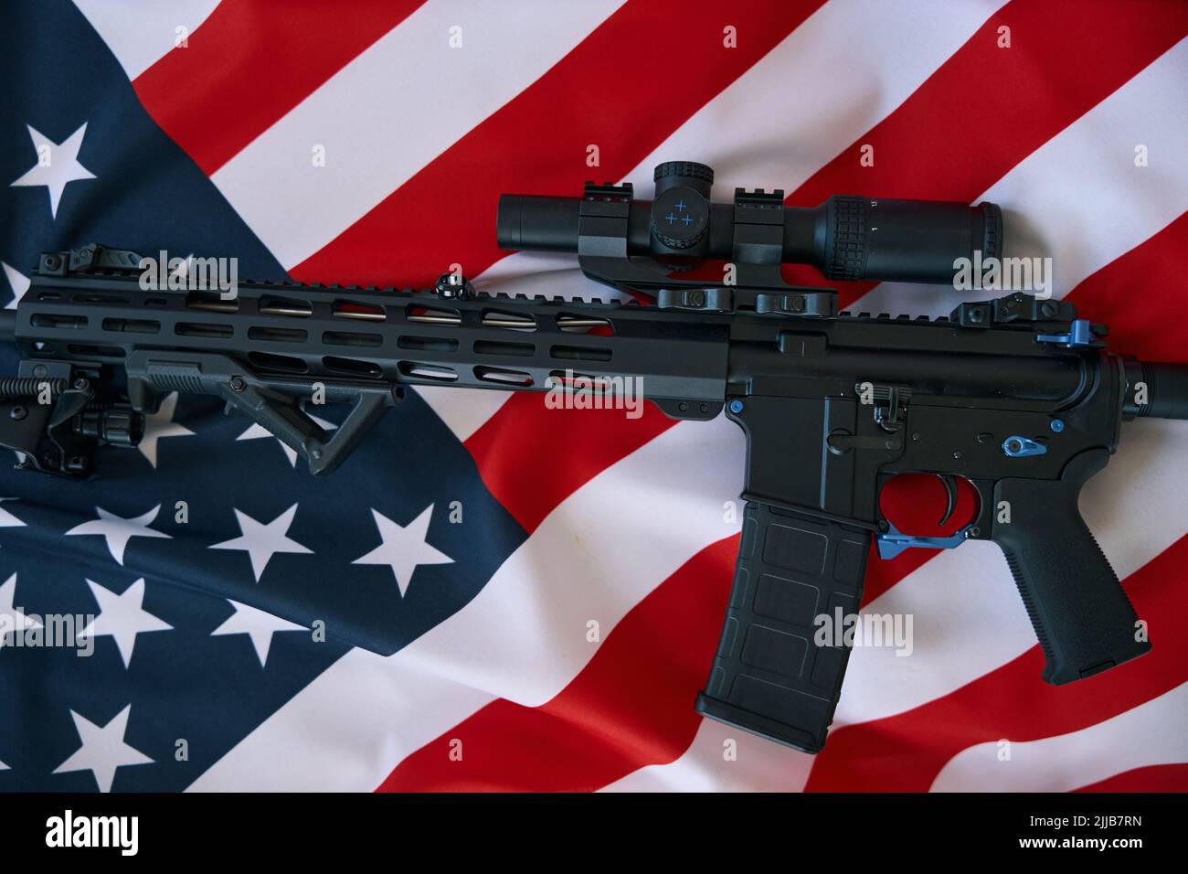 Gun with optical scope on background of American flag Stock Photo - Alamy