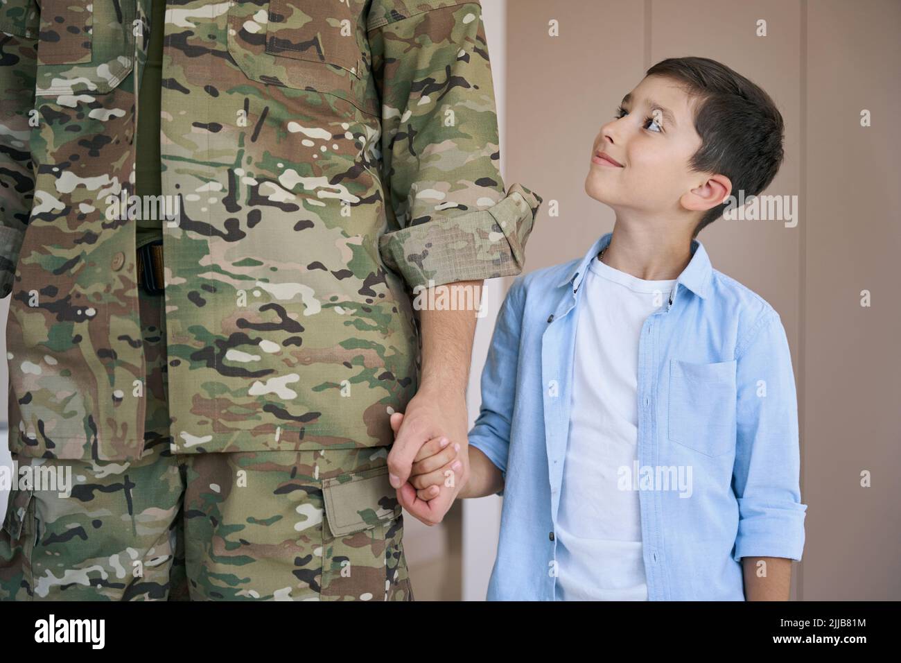 Kid staring at father in military with pride Stock Photo - Alamy