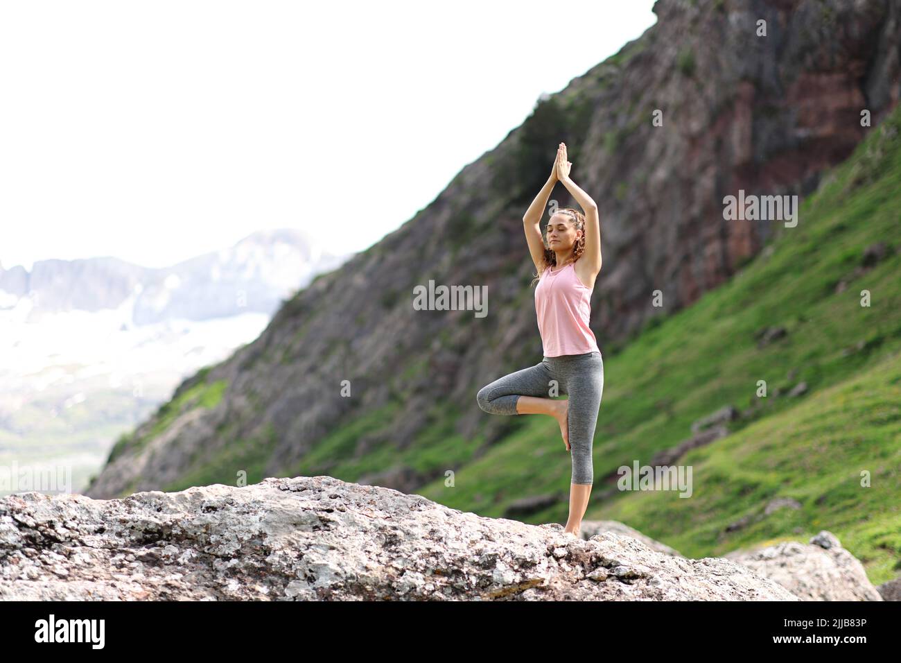 Full body portrait of a yogi doing yoga exercise in the high mountain ...