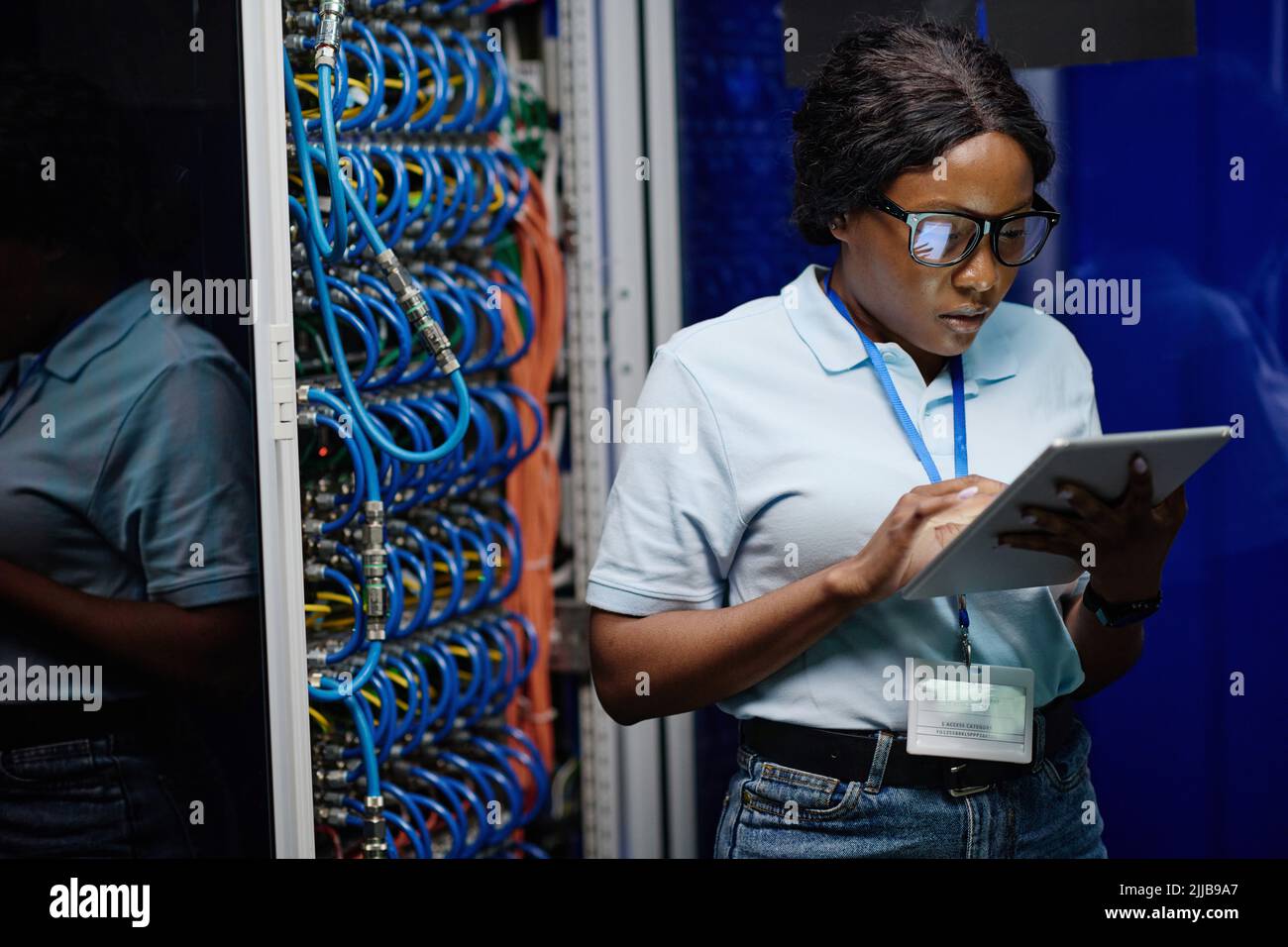 African female engineer setting up the work of computer system using ...