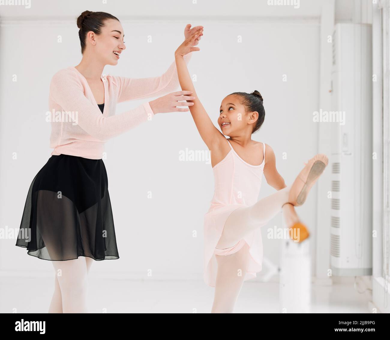 As high as you can, then a little higher. a little girl practicing ...