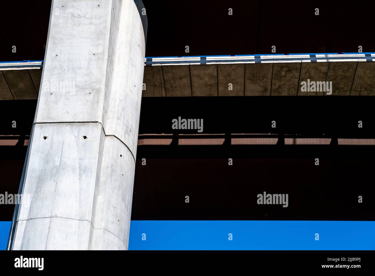 An elevated bridge on a highway with blue sky background Stock Photo ...