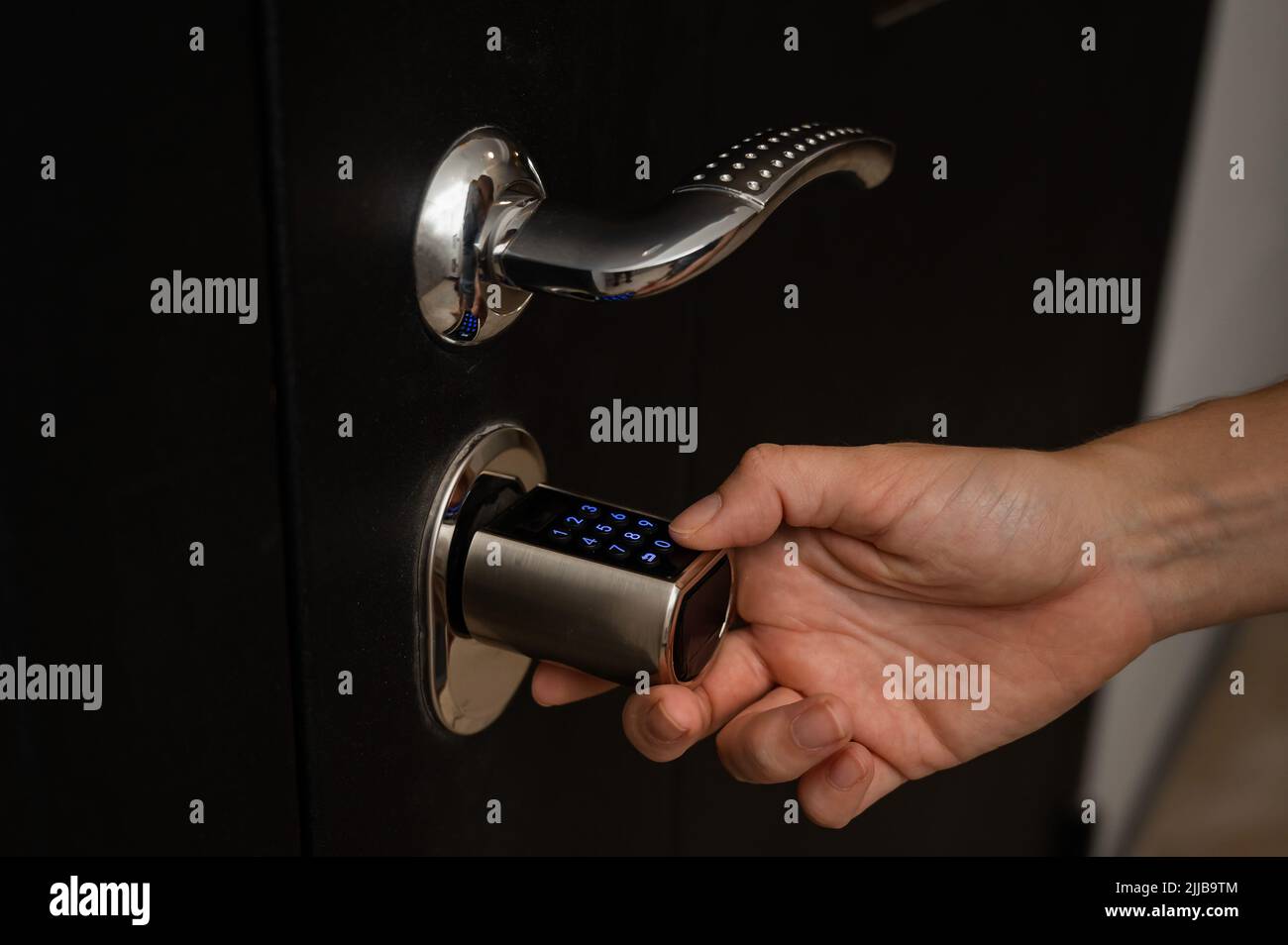 Woman opens the combination lock on the door to the apartment. Keyless ...