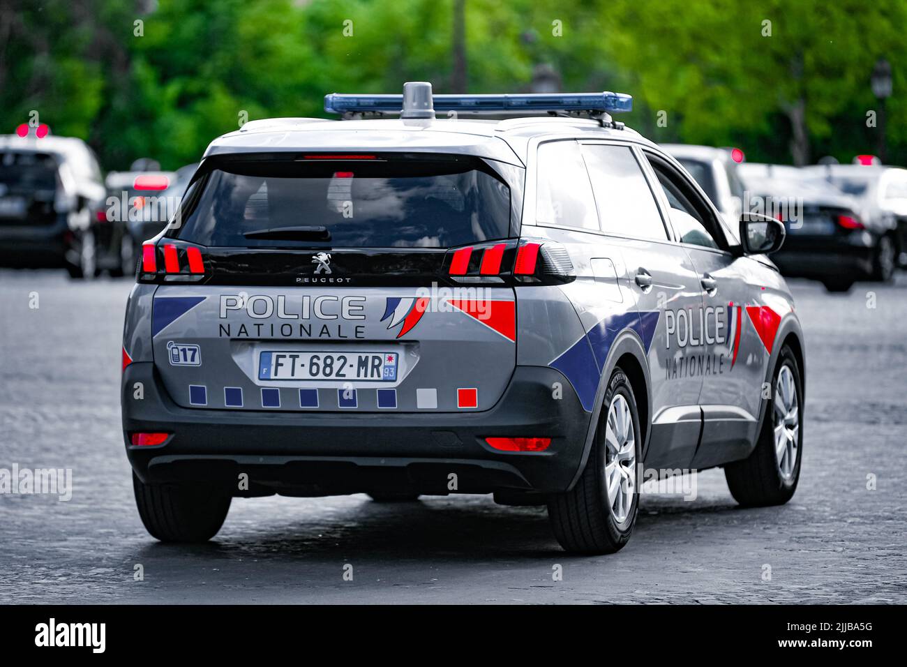 A police car (the new Peugeot 5008) drives through the city ensuring ...