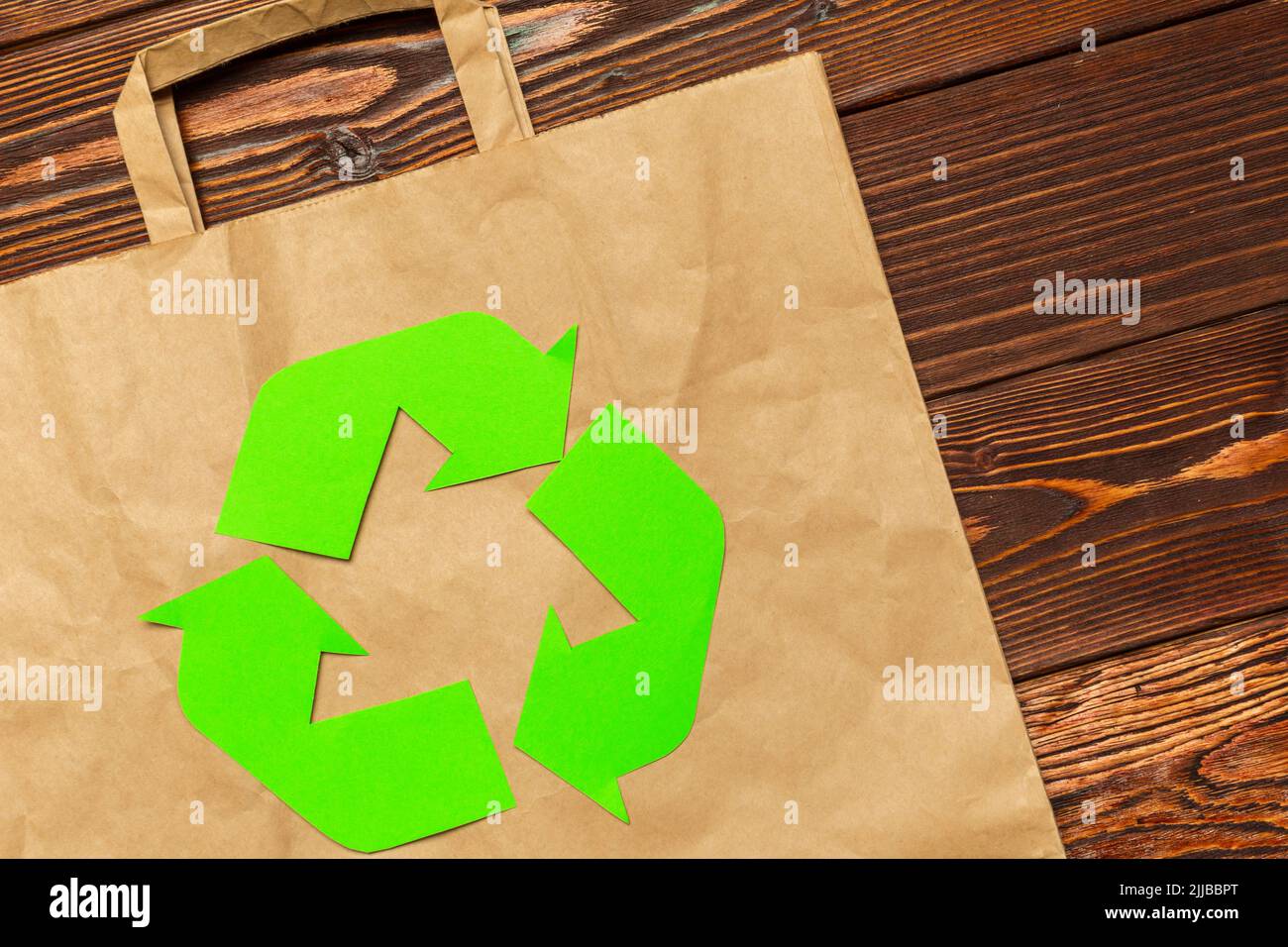 Eco concept with recycling symbol on table background top view Stock ...