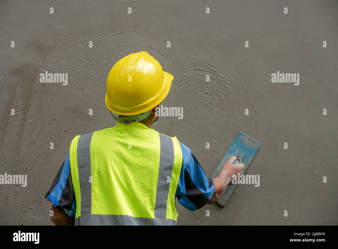 Plasterers are plastering walls in building construction with mortar ...