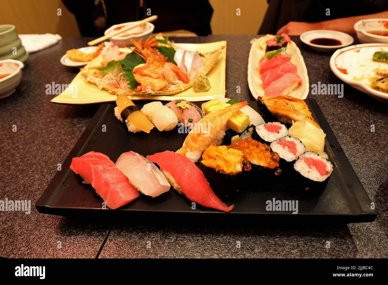 Close up assorted Sushi rolls and Sashimi- Salmon, Tuna, Shrimp, Eel ...