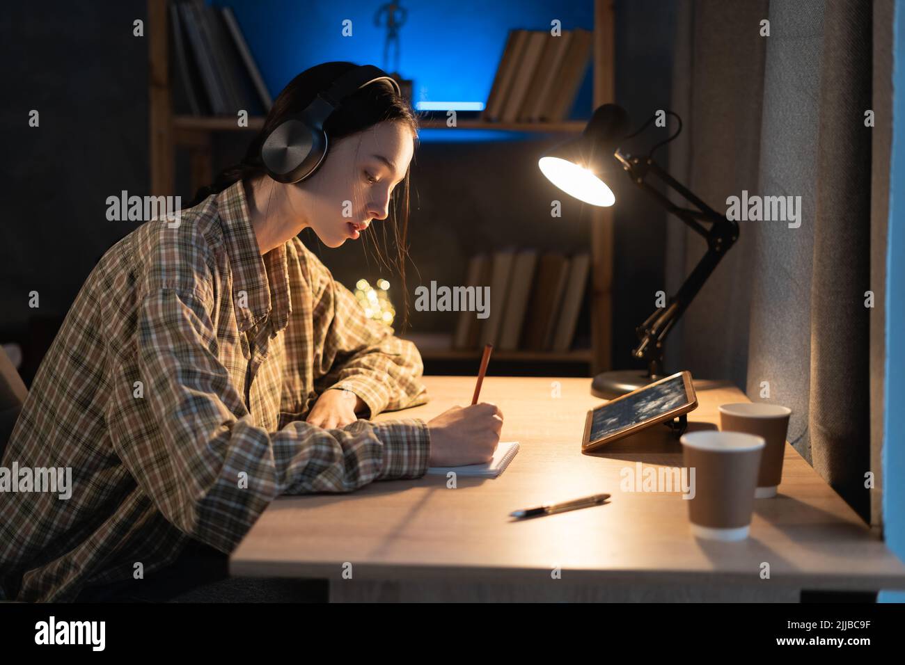 asian girl student doing homework with digital tablet at home late at ...