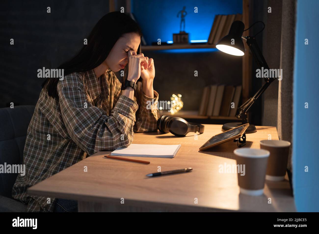 Fatigued asian woman student suffering eyestrain using tablet pc ...