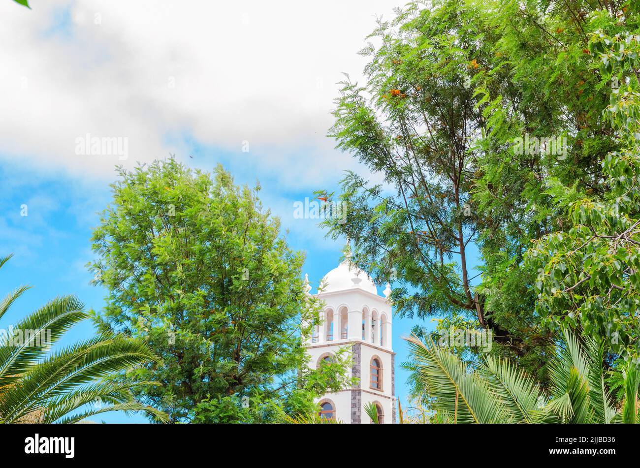 Santa Ana Church Tower in Garachico village with tropical palm leaves ...