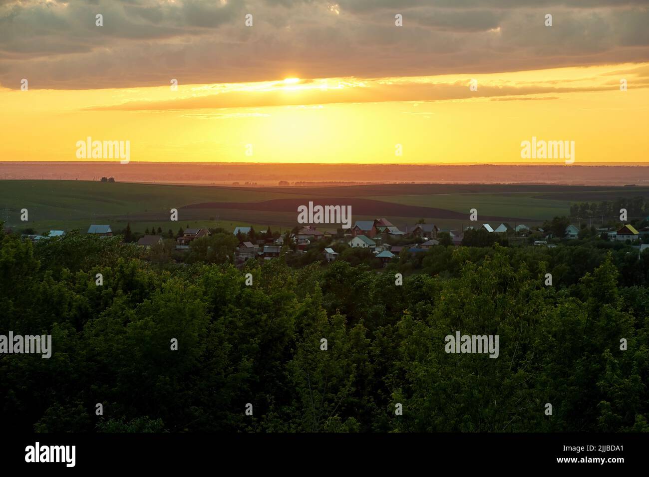 Panoramic view of the sunset over the valley and the village. Landscape ...