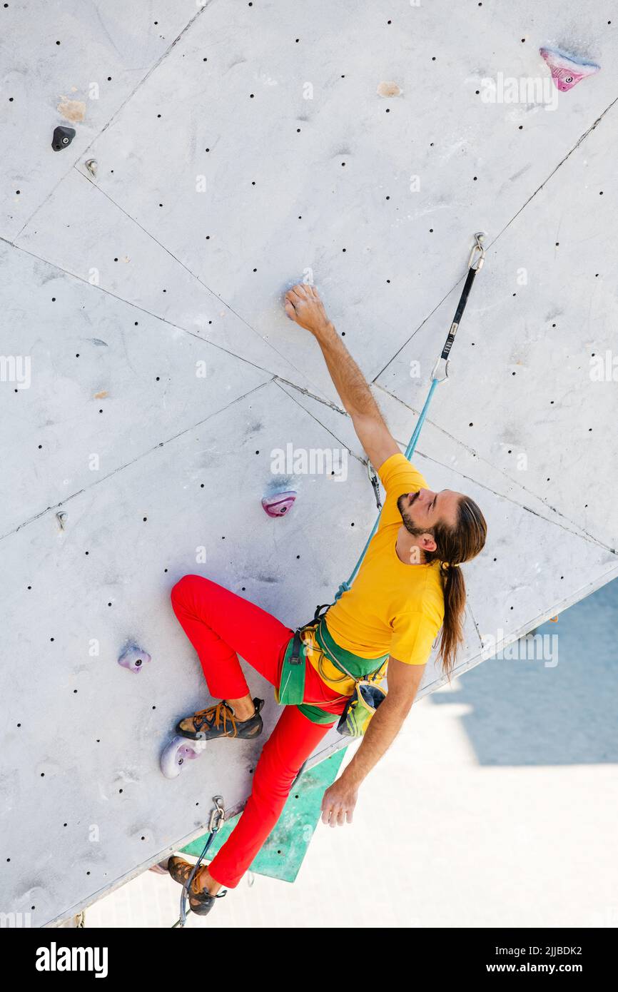 Young and fit man exercise free mountain climbing on outdoor practice ...