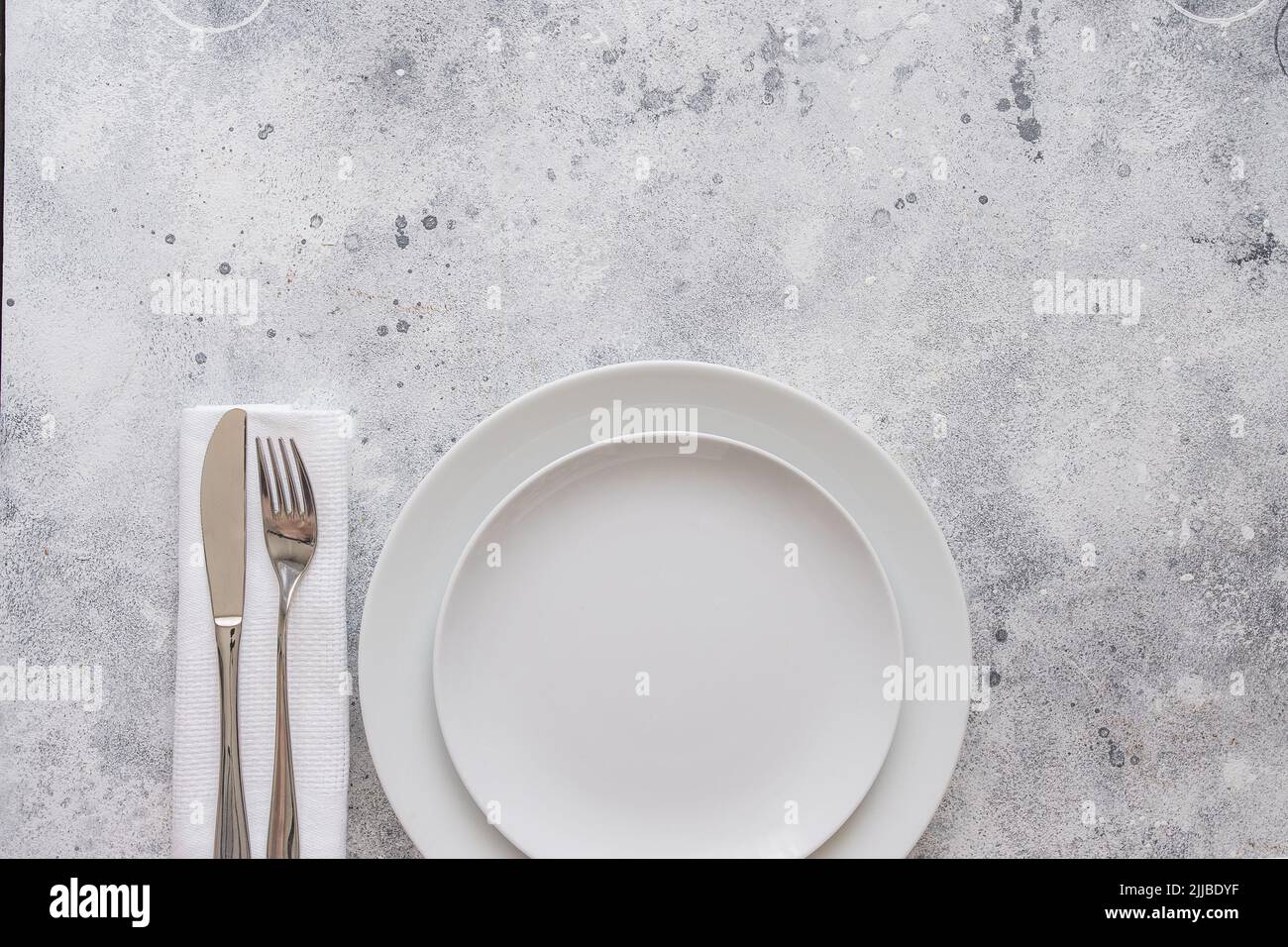 Table set with silver cutlery with plate. Dinning concept background ...