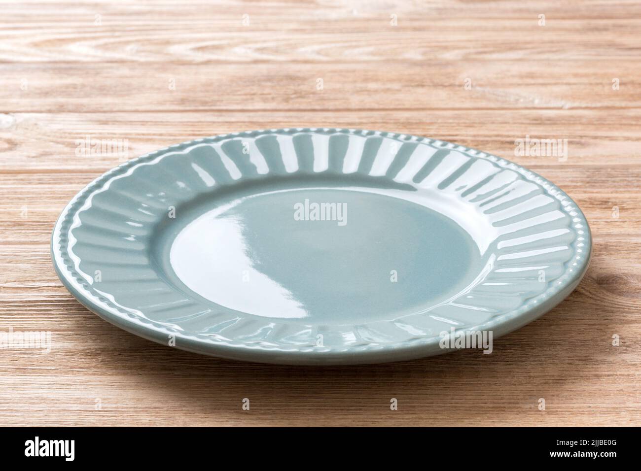 Perspective view of empty grey plate on cement background. Empty space ...
