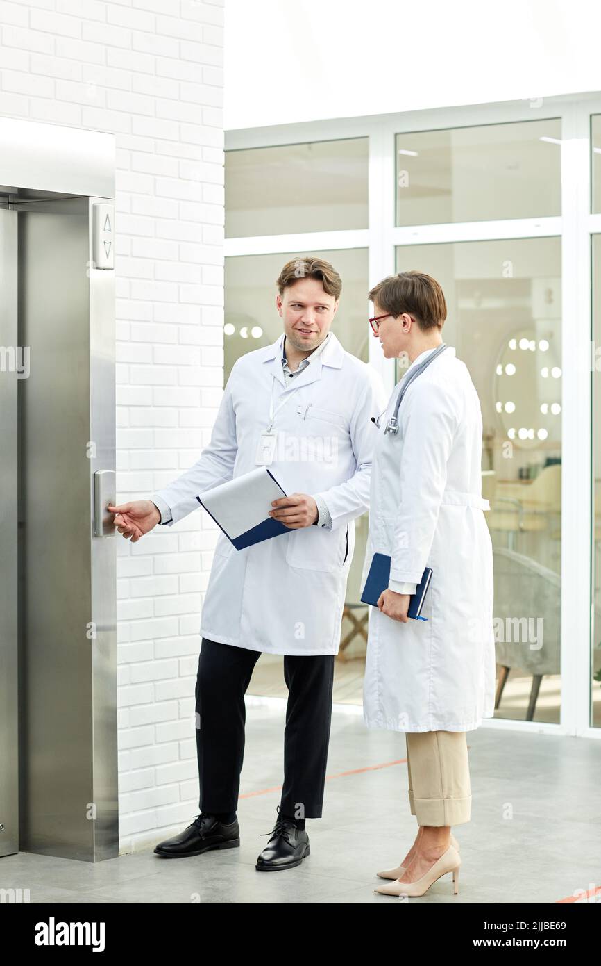 Vertical full length portrait of two medical professionals waiting for ...