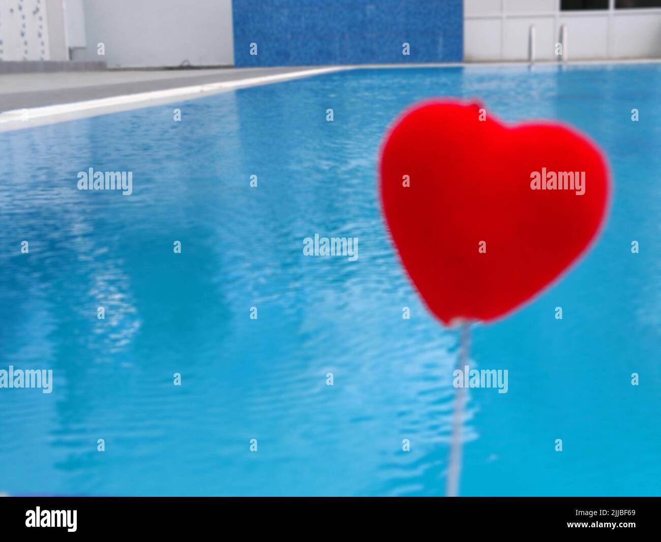 Picture of wet red heart by the pool. Valentine's Day love heart nature ...