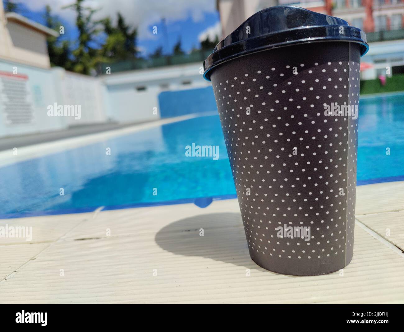 A reusable cup of coffee by the swimming pool Stock Photo - Alamy