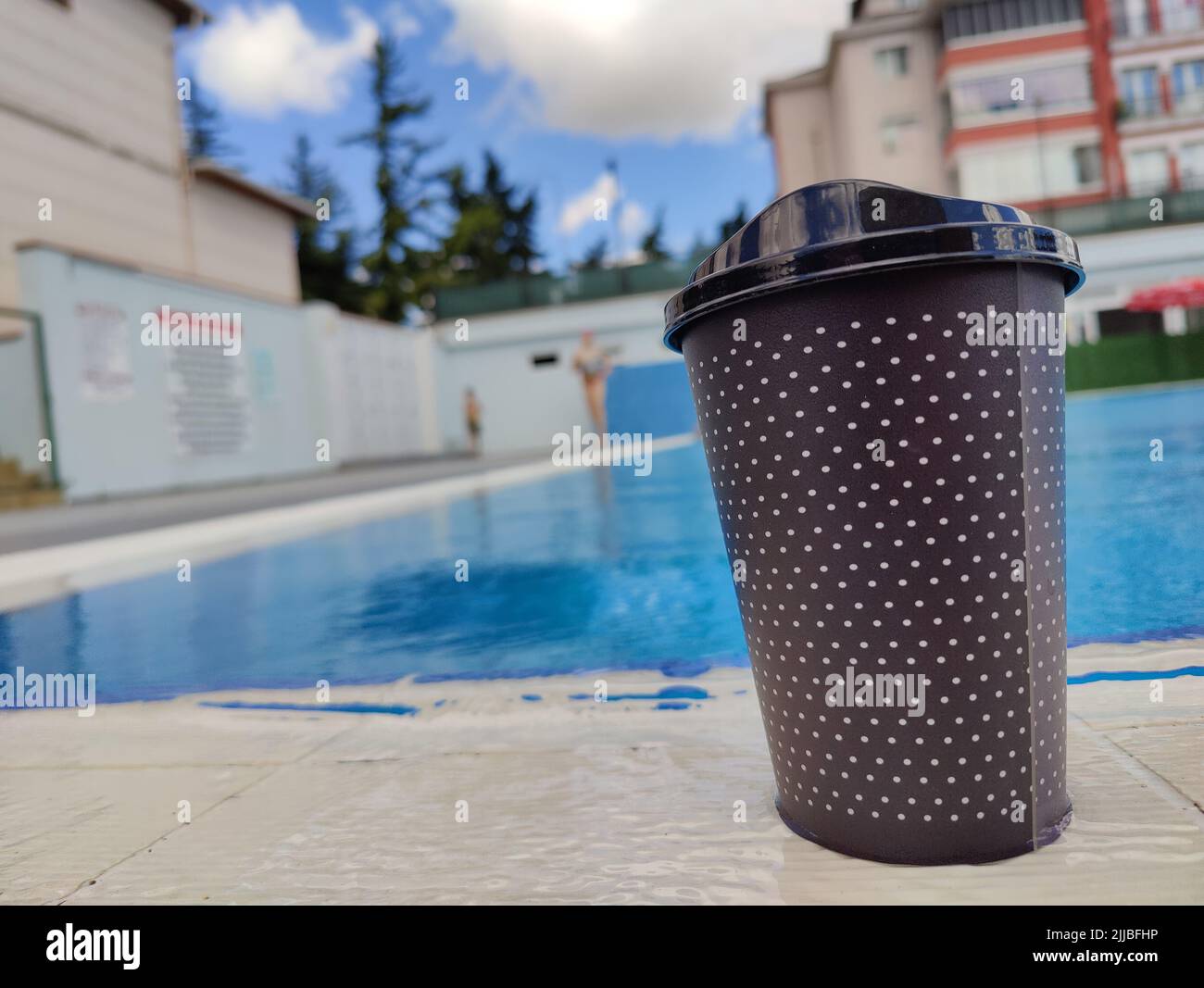 A reusable cup of coffee by the swimming pool Stock Photo - Alamy