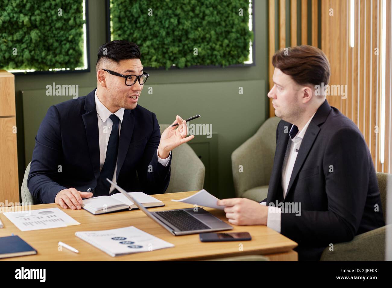 Portrait of successful Asian businessman wearing suit in meeting with ...