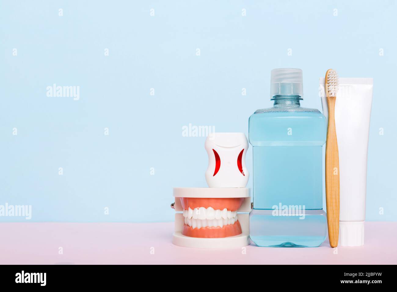 Mouthwash and other oral hygiene products on colored table top view ...
