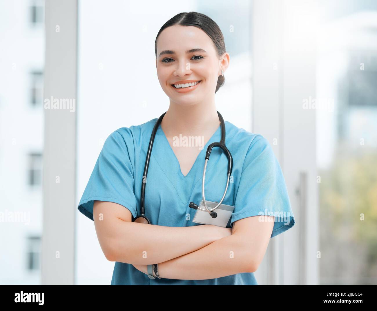 Im ready to take on the day. a young female doctor standing with her ...