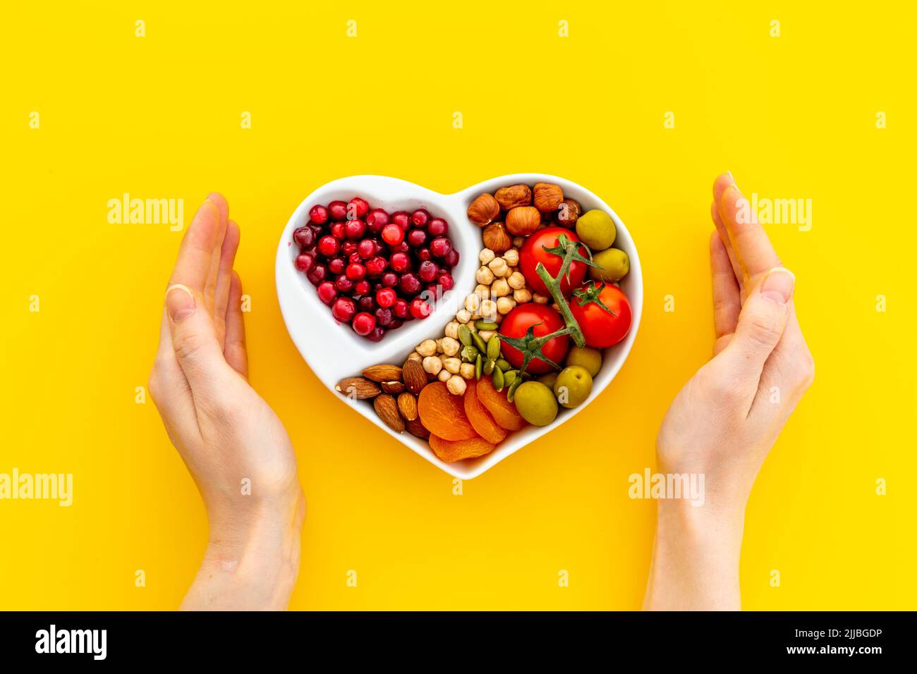 Hands with heart shaped dish of healthy diet food Stock Photo - Alamy