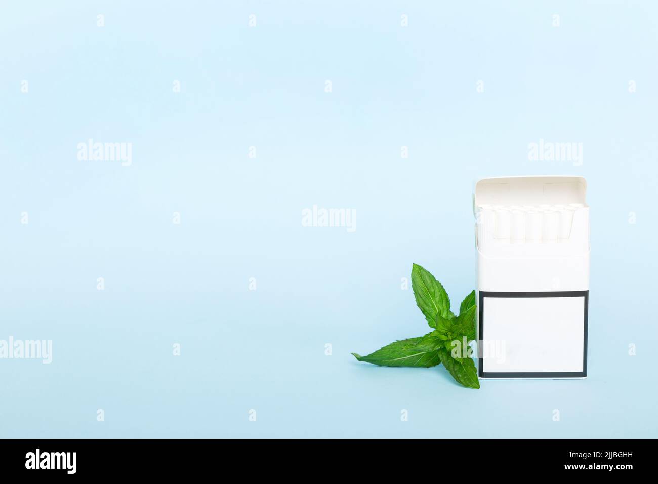 Pack of menthol cigarettes and fresh mint on colored table, Menthol ...