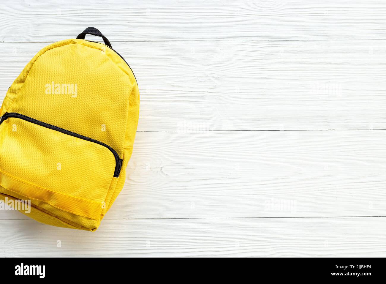 Yellow school backpack. Back to school concept. Top view Stock Photo ...