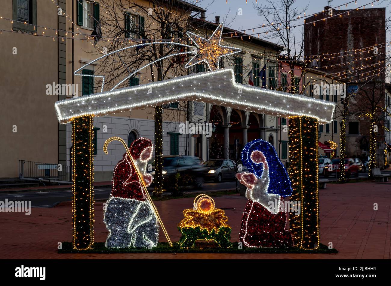 A Christmas nativity scene made with colored lights in the historic ...