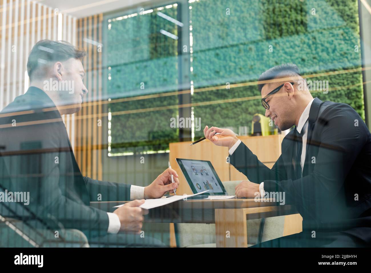 Low angle portrait of two successful business people wearing suits ...