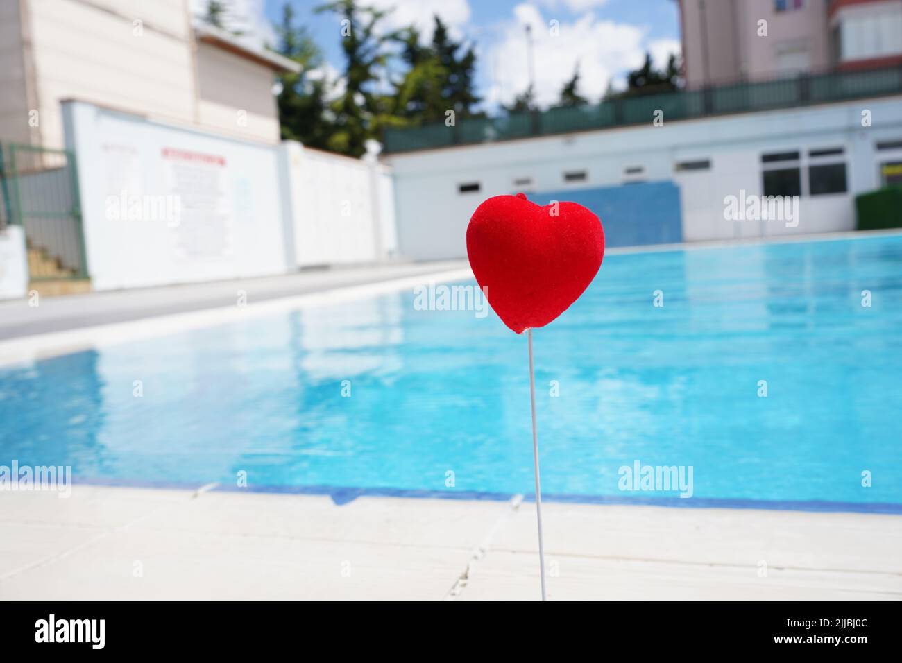 Picture of wet red heart by the pool. Valentine's Day love heart nature ...