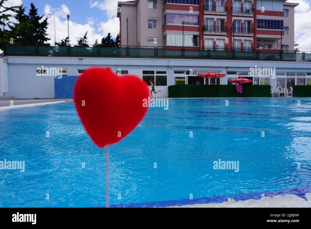 Picture of wet red heart by the pool. Valentine's Day love heart nature ...