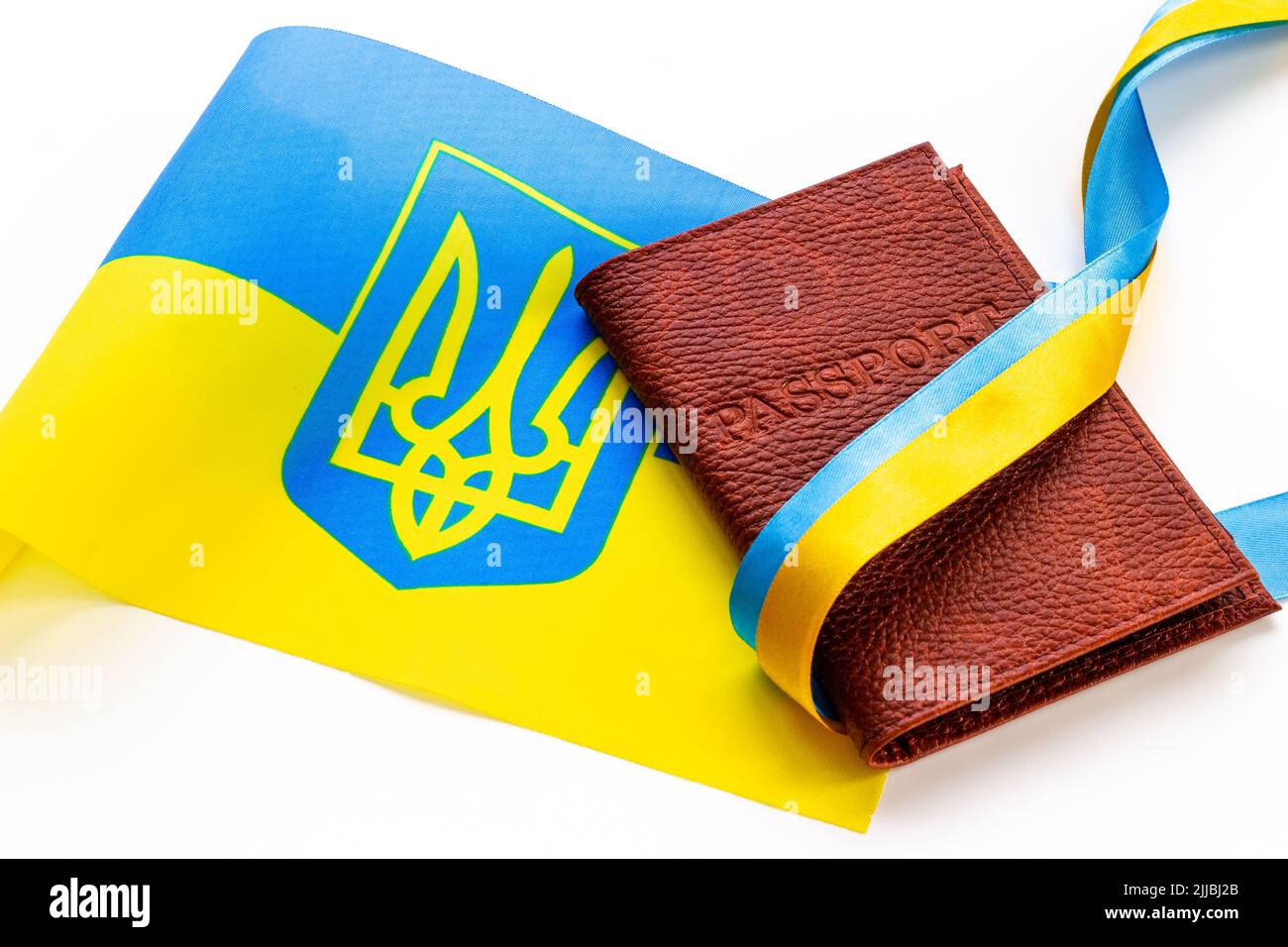 Ukrainian immigration concept - yellow and blue ribbon on passport ...
