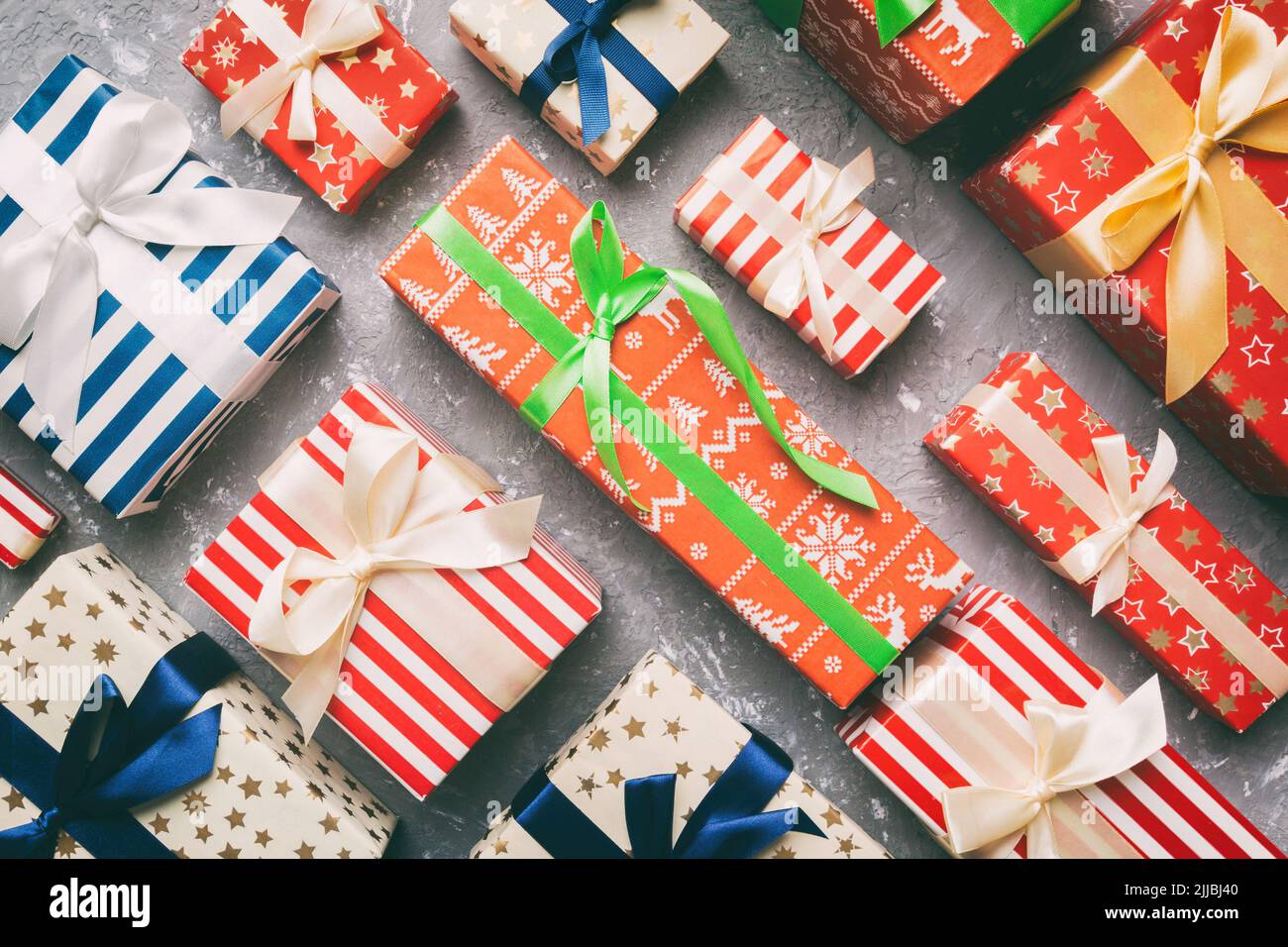 A lot of Christmas gift boxes in colored paper decorated on table, Top ...
