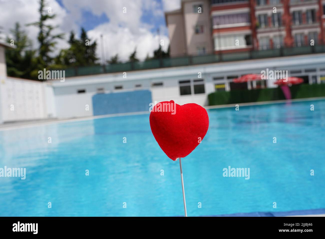 Picture of wet red heart by the pool. Valentine's Day love heart nature ...