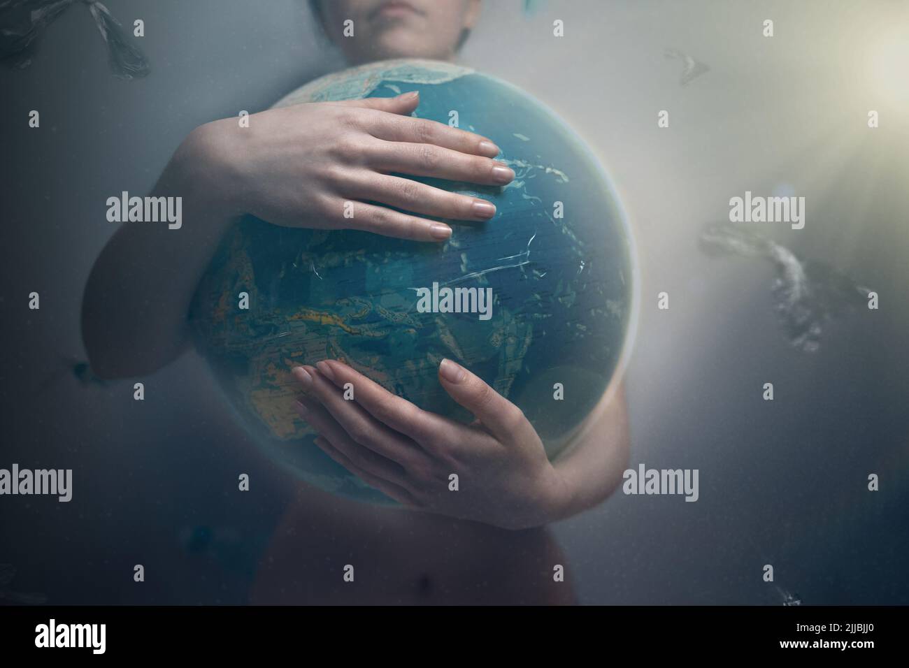 Woman embracing the globe of planet Earth. The concept of preserving ...