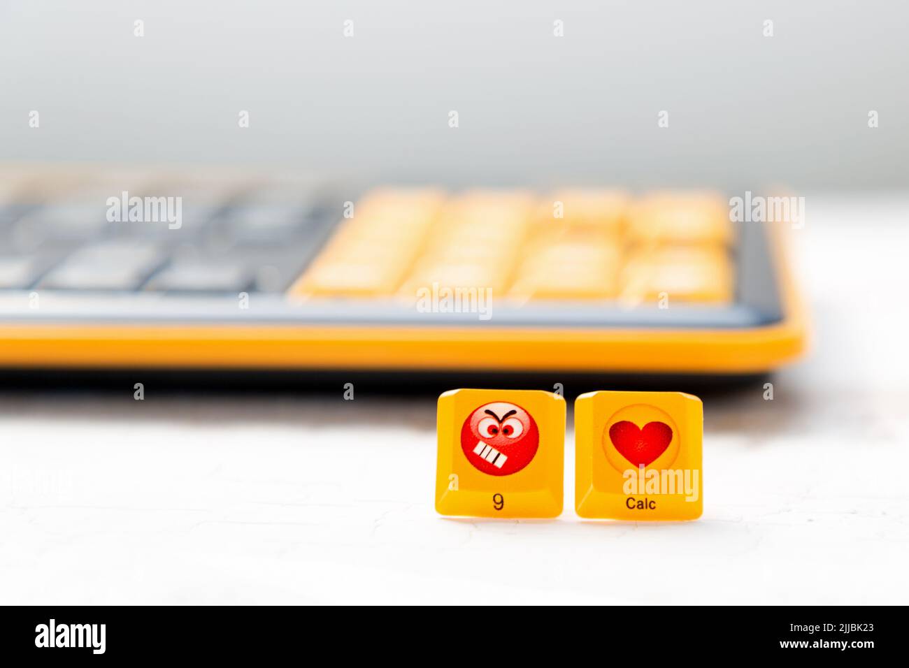 Two buttons with the image of an angry emoticon and a heart on the ...