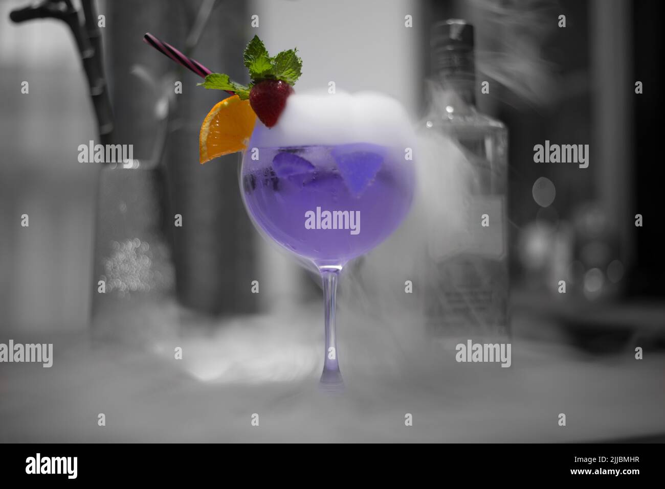 Relaxing evening having a special purple cocktail with friends. Magic ...