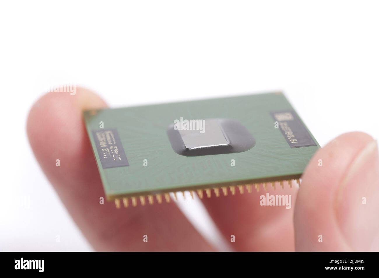 Macro view of fingers of person holding microchip, white background ...