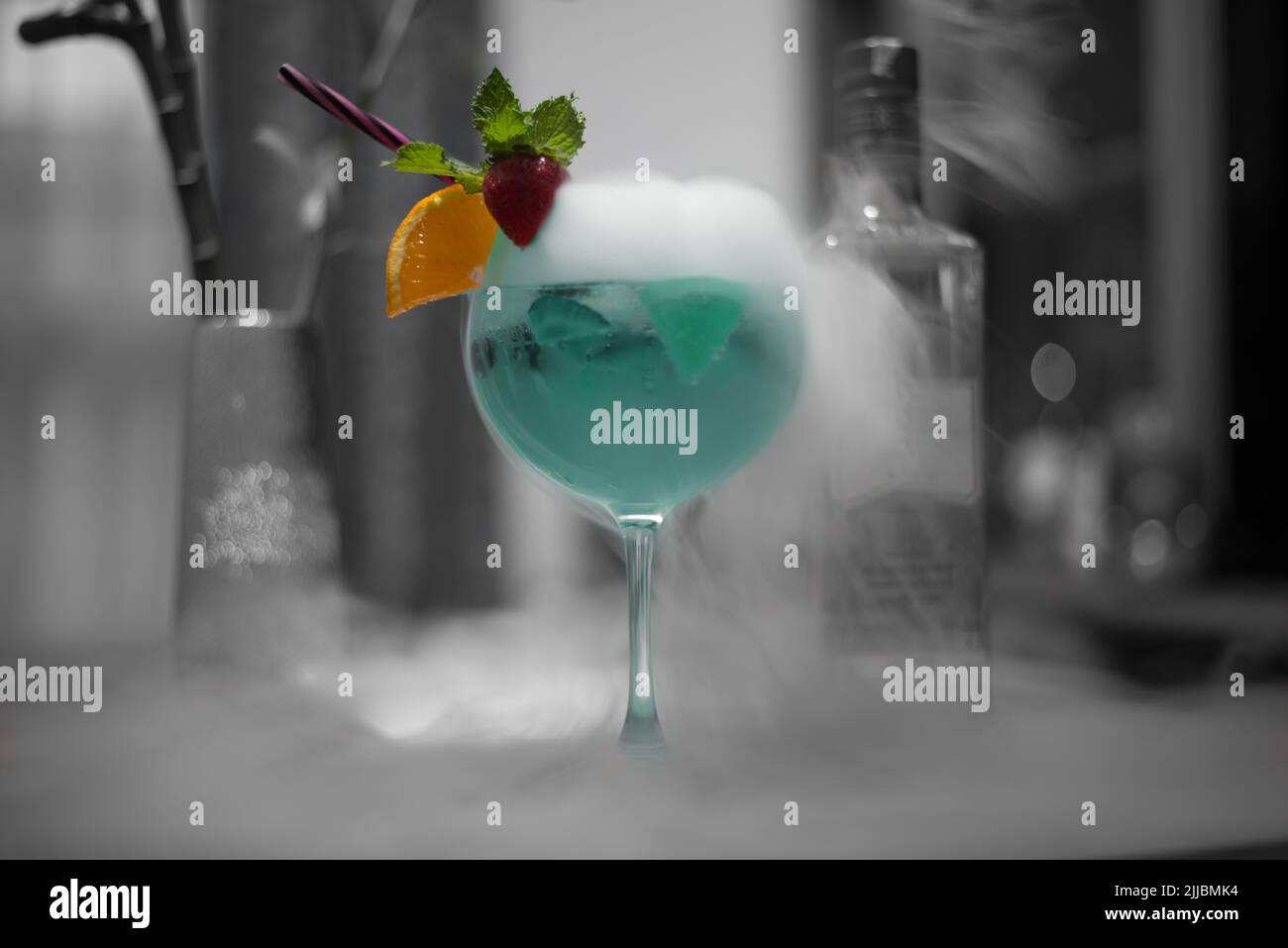 Relaxing evening having a special turquoise cocktail with friends ...