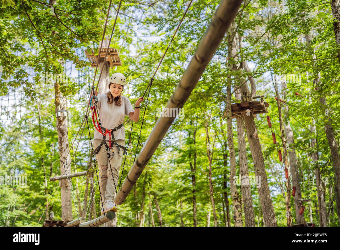 Happy women girl female gliding climbing in extreme road trolley ...