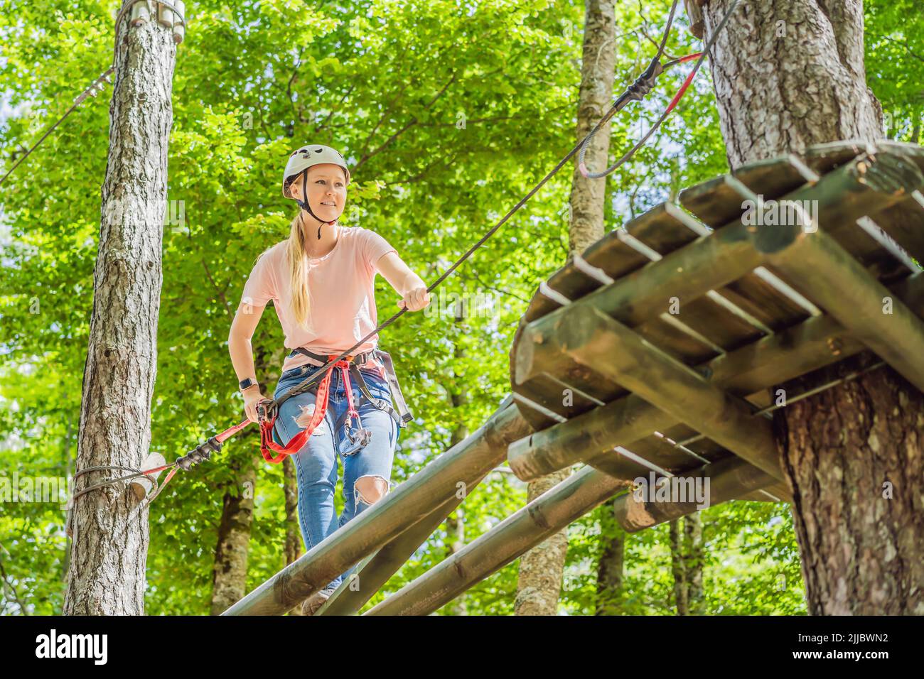 Happy women girl female gliding climbing in extreme road trolley ...