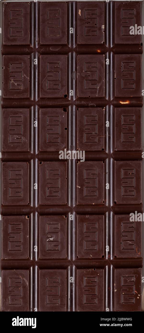 rectangular bar of dark natural chocolate divided into equal slices ...