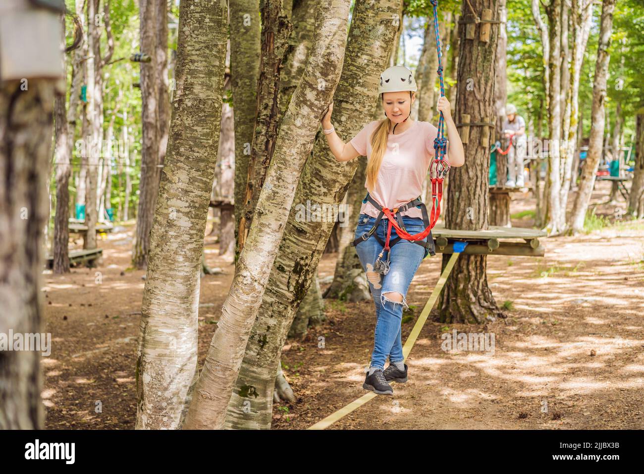 Happy women girl female gliding climbing in extreme road trolley ...