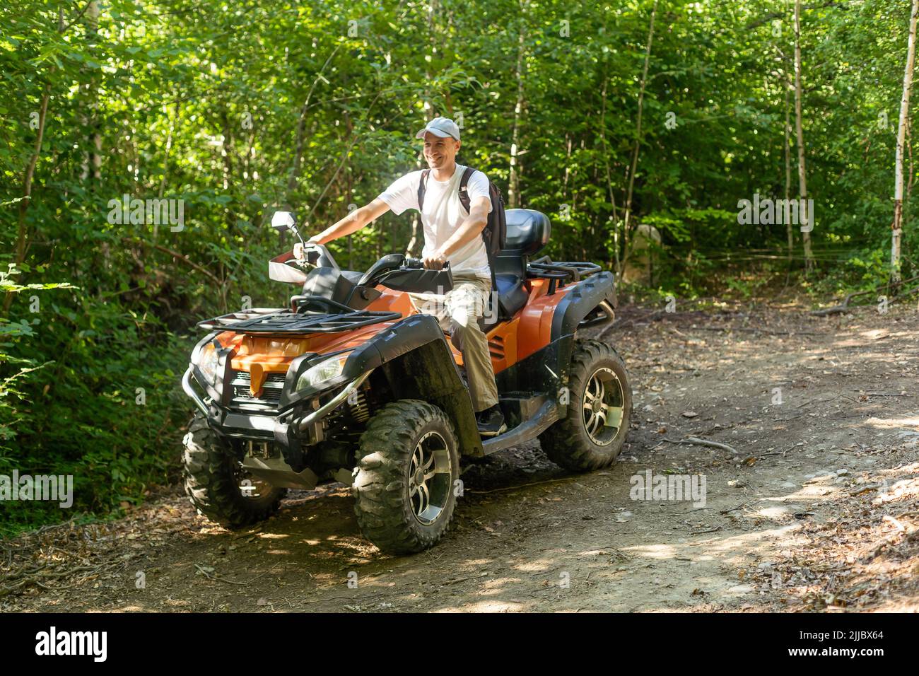 Man on the ATV Quad Bike on the mountains road Stock Photo - Alamy