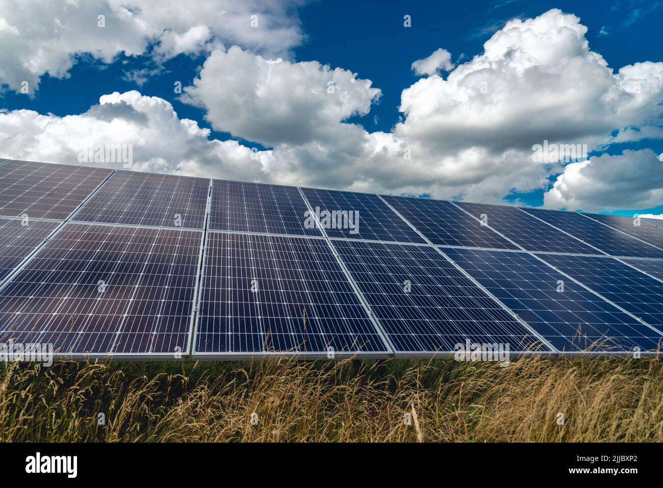 Solar panels and blue sky with clouds Stock Photo - Alamy