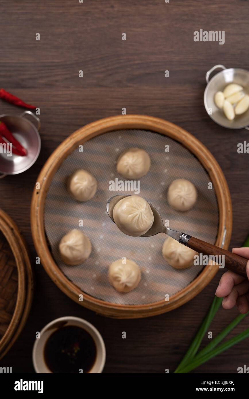 Eating steamed pork soup dumplings named Xiao long bao xiaolongbao in ...