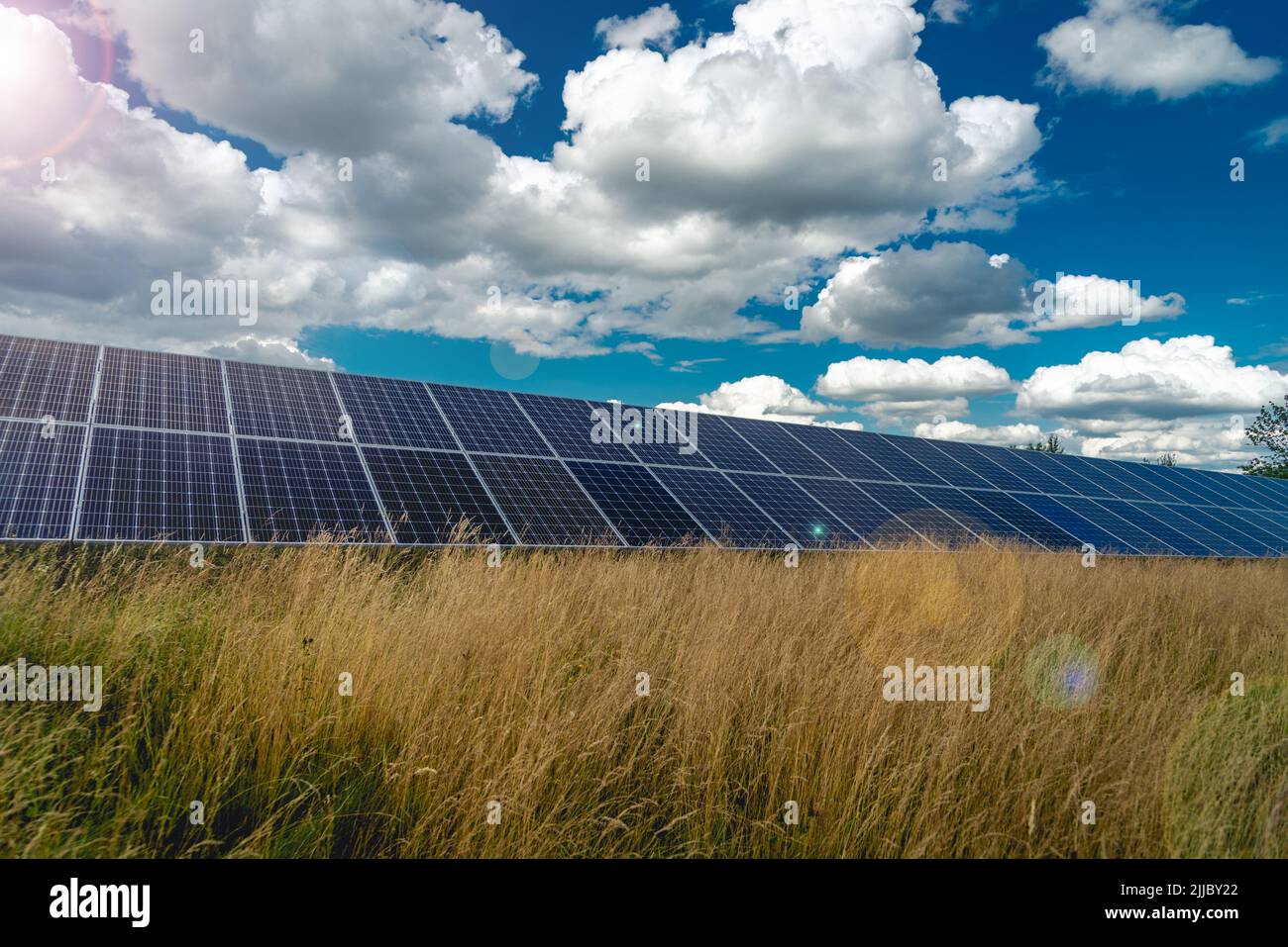 Solar panels and blue sky with clouds Stock Photo - Alamy