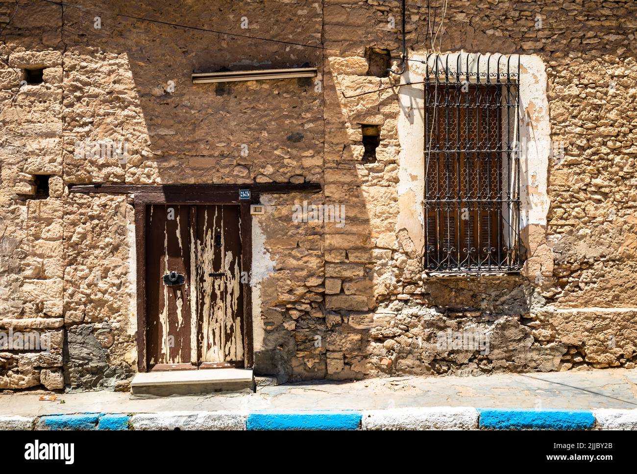 The entrance to an ancient traditional house in El Jem, Tunisia. El Jem ...
